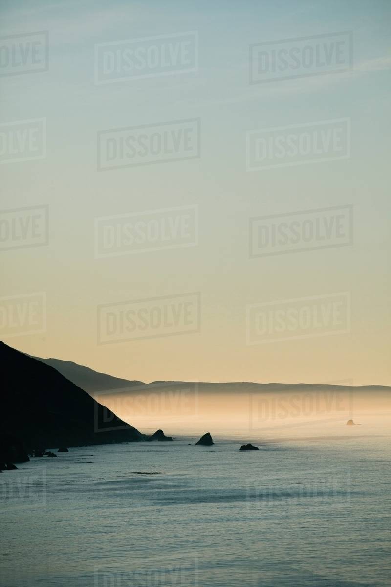 Fog rolling over ocean - Stock Photo - Dissolve