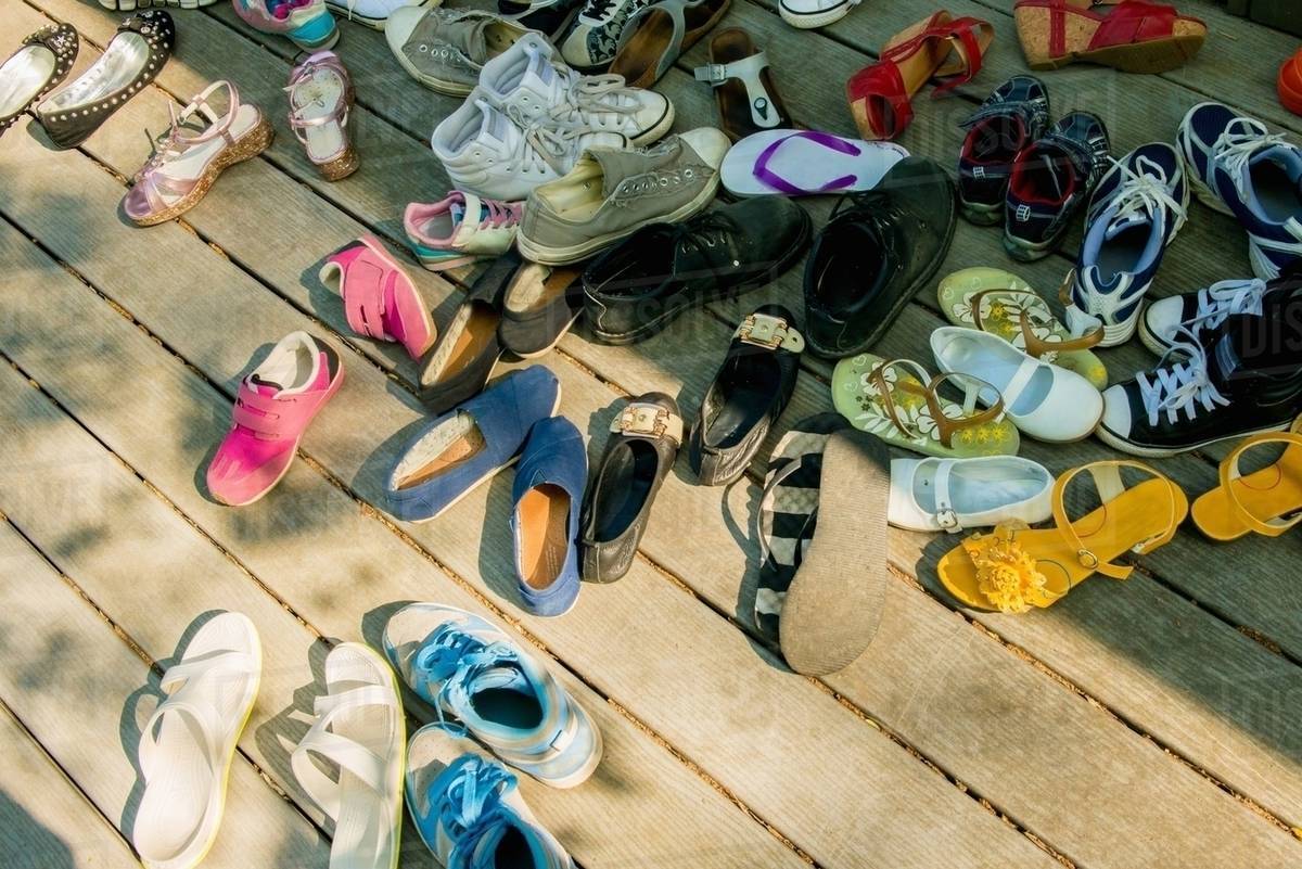 Large group of shoes on wooden planks - Royalty-free Stock Photo | Dissolve