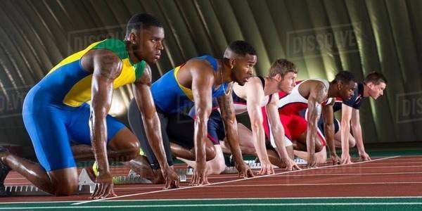 Athletes on start line of race - Stock Photo - Dissolve