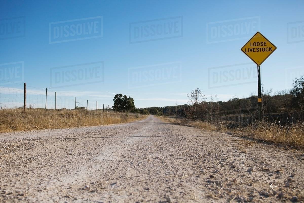 Empty dirt road with sign, Texas, USA - Royalty-free Stock Photo | Dissolve
