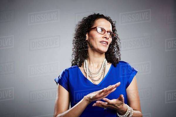 Studio portrait of mature woman clapping - Stock Photo - Dissolve