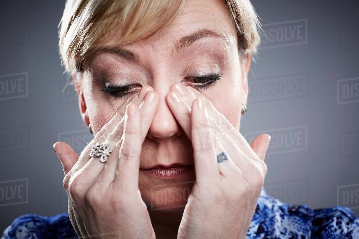 Portrait of mature woman, wiping away tears from eyes - Royalty-free ...