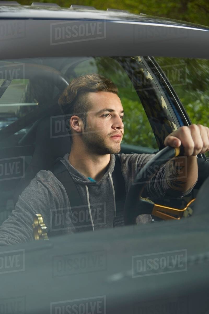 Portrait of man driving looking through windscreen - Royalty-free Stock ...