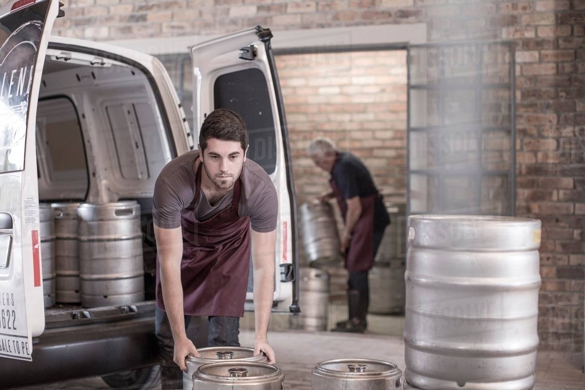 Brewers loading kegs into back of van - Royalty-free Stock Photo | Dissolve