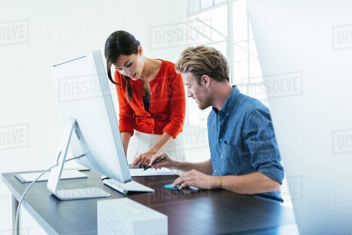 Business people working on computer by office window - Stock Photo ...