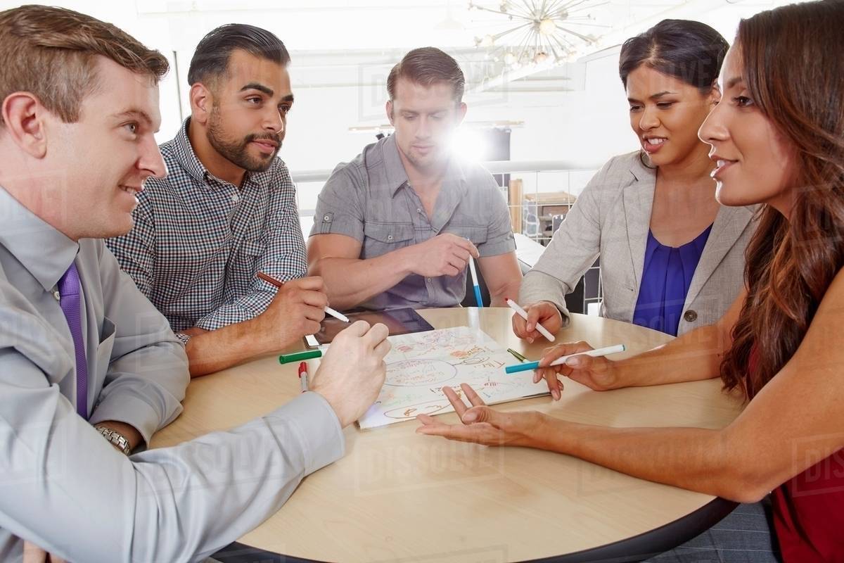 Small group of people having brainstorming business meeting - Royalty ...
