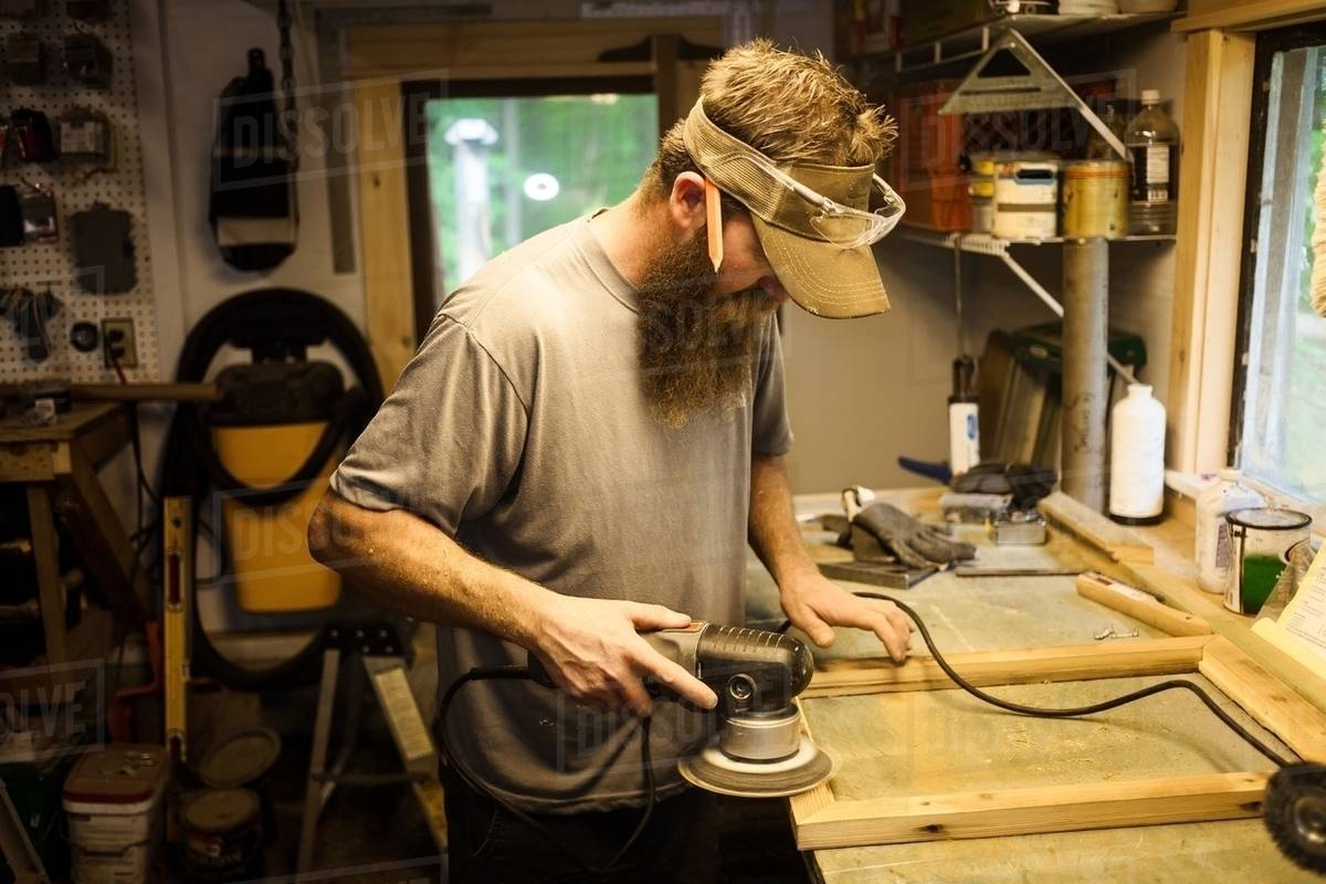 Wood artist working in workshop, using machinery - Royalty-free Stock ...