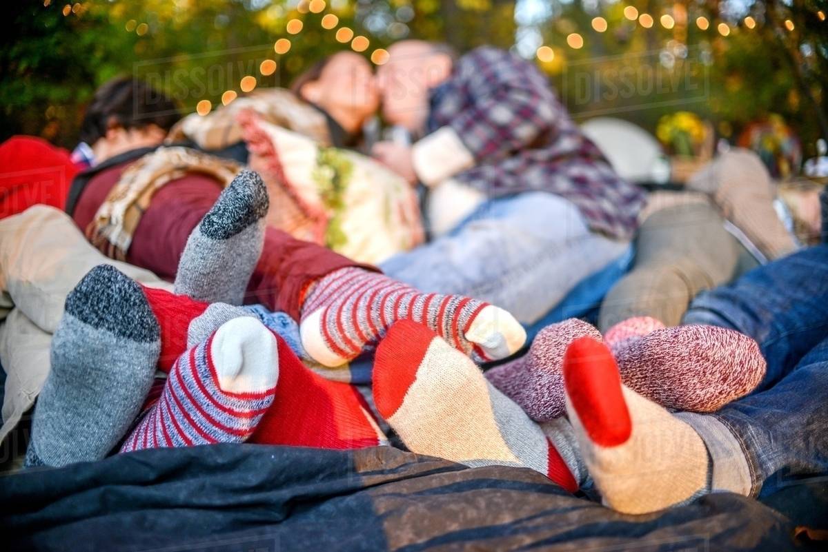 Entwined family socked feet lying on blanket in woods - Royalty-free ...
