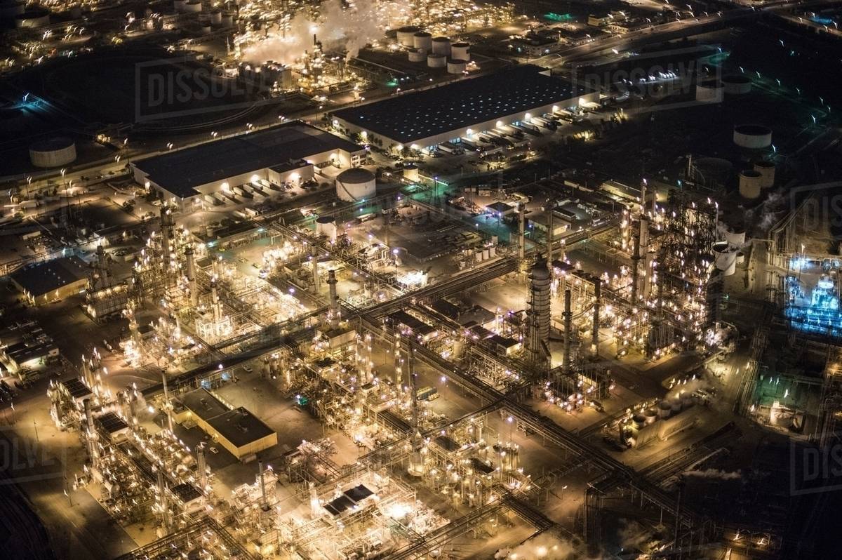 Aerial view of oil refinery illuminated at night, Los Angeles ...