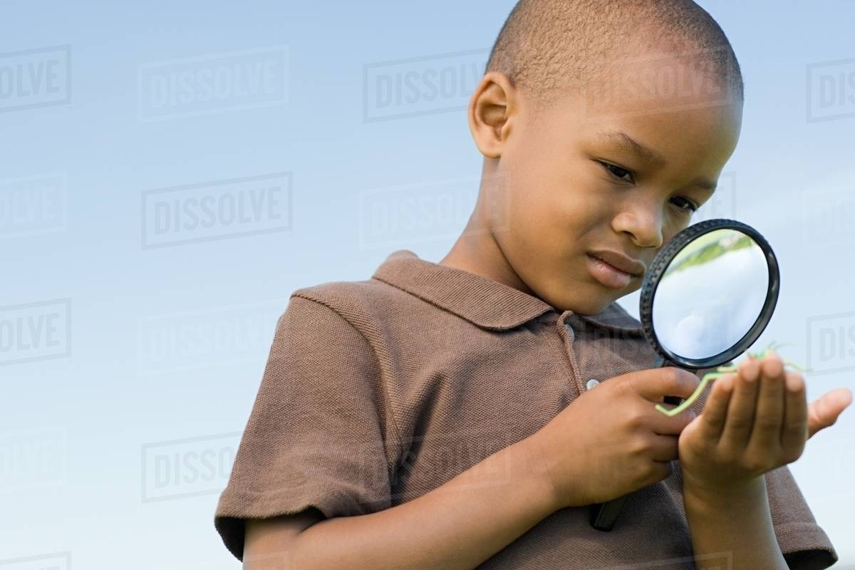 Boy with a magnifying glass - Royalty-free Stock Photo | Dissolve