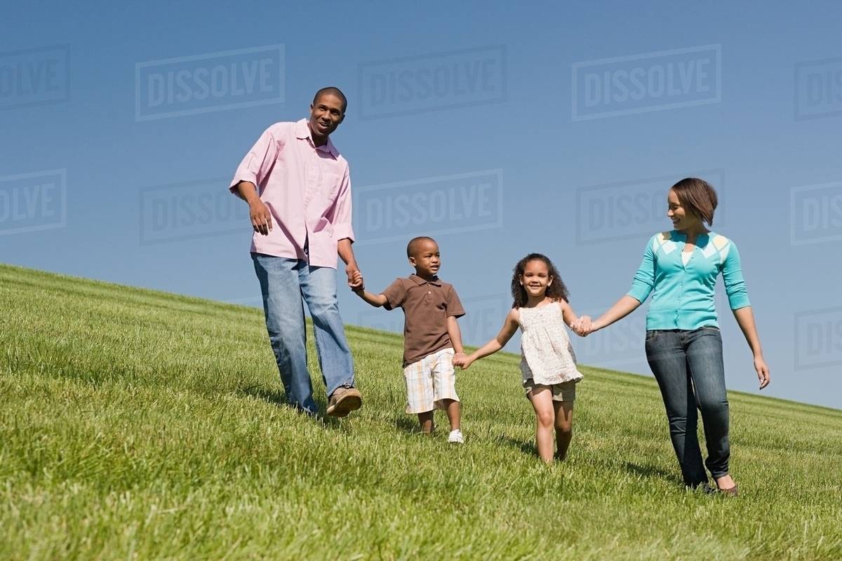 Family in a field - Royalty-free Stock Photo | Dissolve