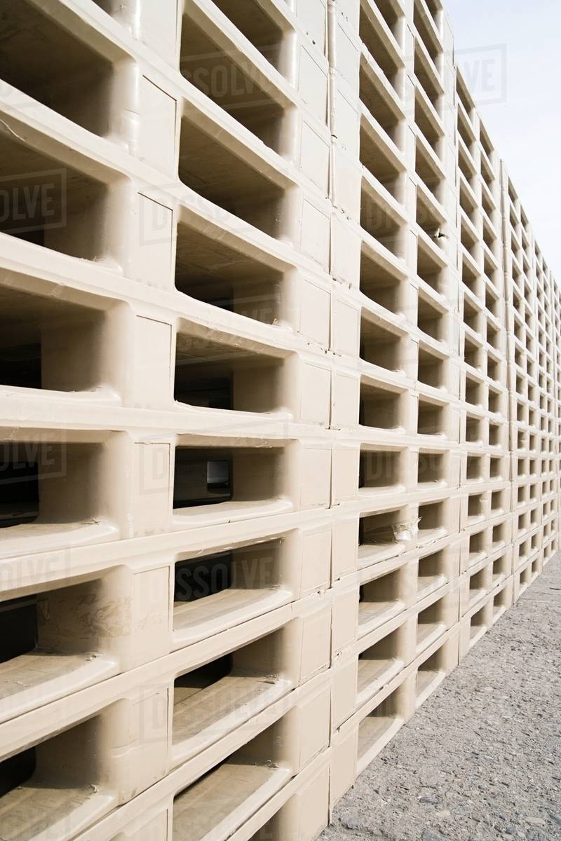 Pallets stacked in a row - Royalty-free Stock Photo | Dissolve