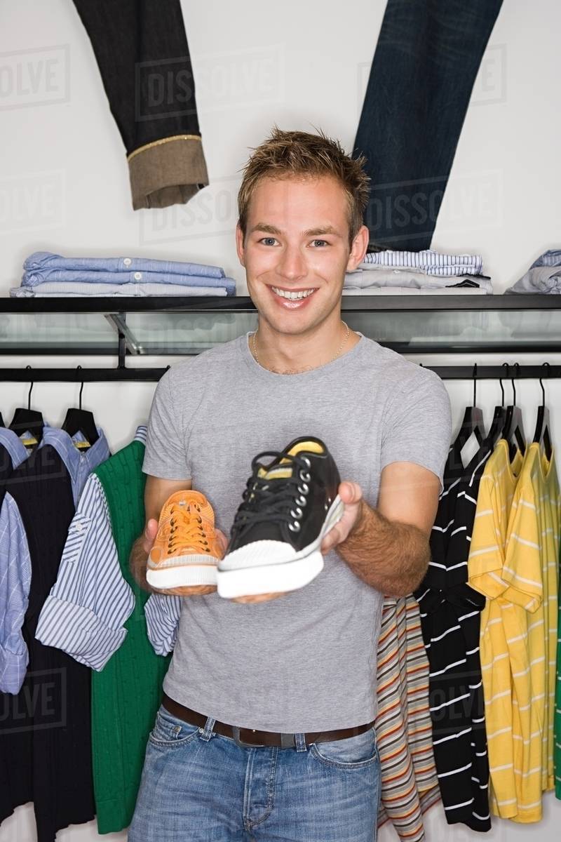 Young man clothes shopping - Royalty-free Stock Photo | Dissolve