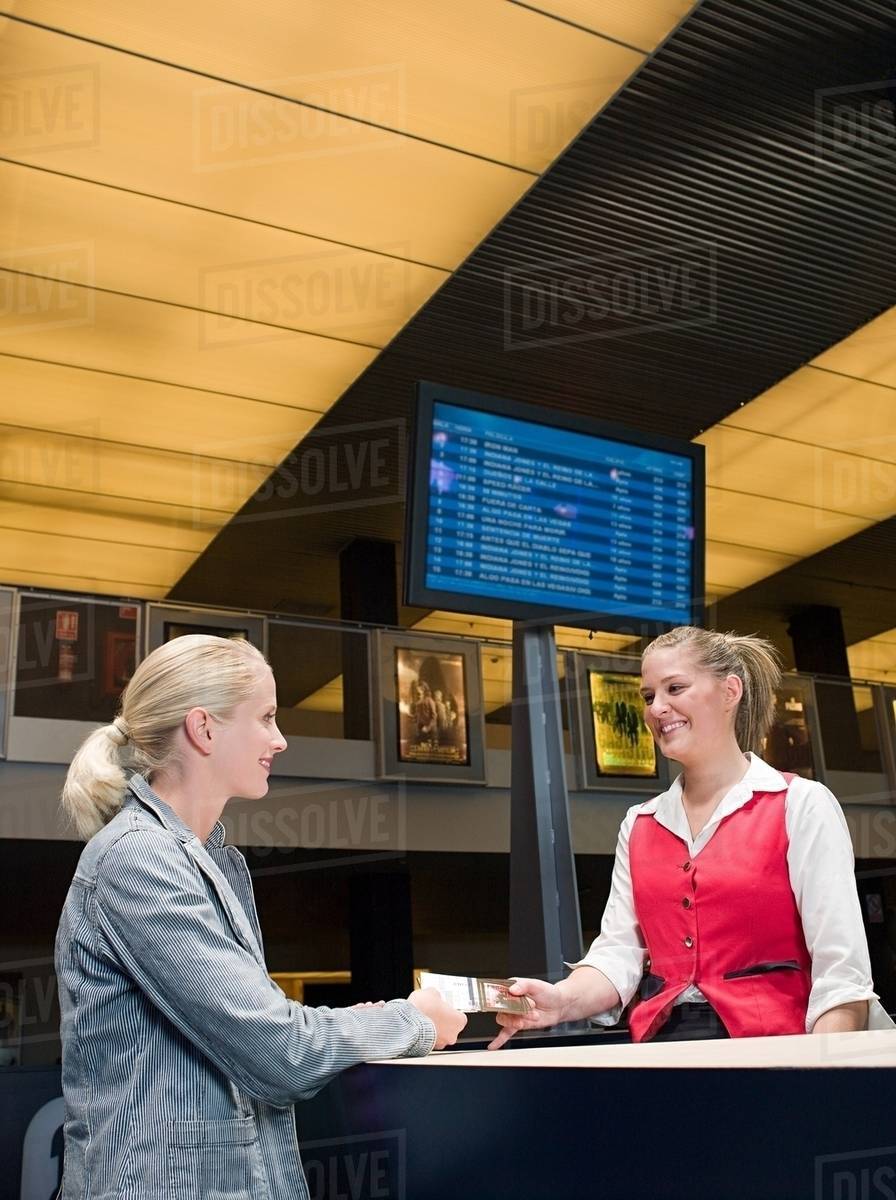 A woman buying a ticket from the box office - Royalty-free Stock Photo ...