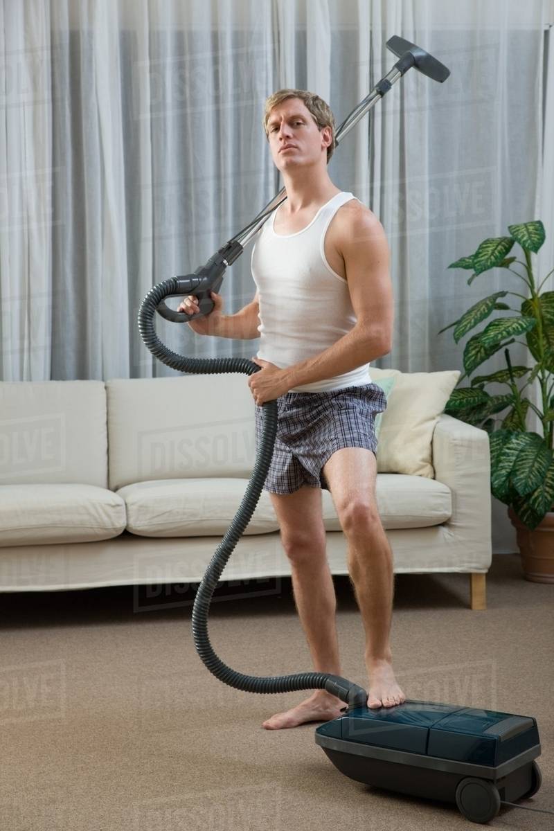 Portrait of a man with a vacuum cleaner - Stock Photo - Dissolve