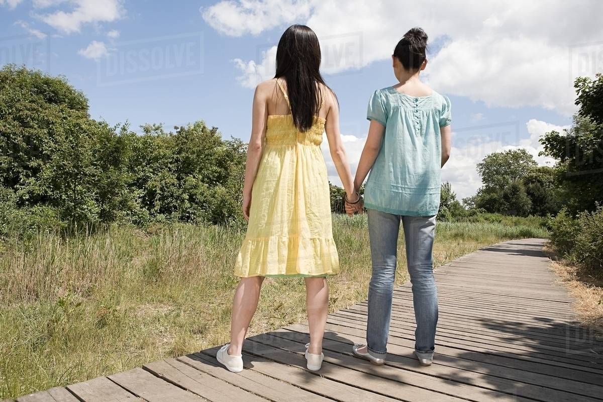 Two women holding hands - Royalty-free Stock Photo | Dissolve