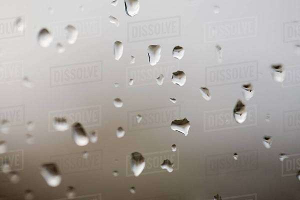 Rain droplets on a window - Stock Photo - Dissolve