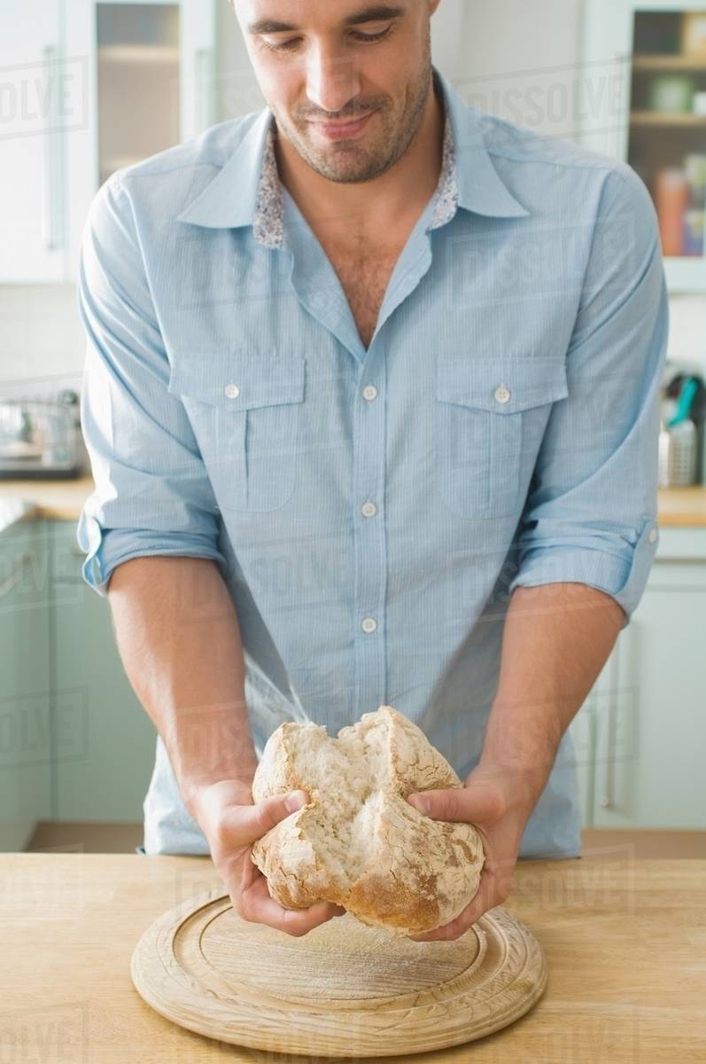 Man holding bread - Royalty-free Stock Photo | Dissolve