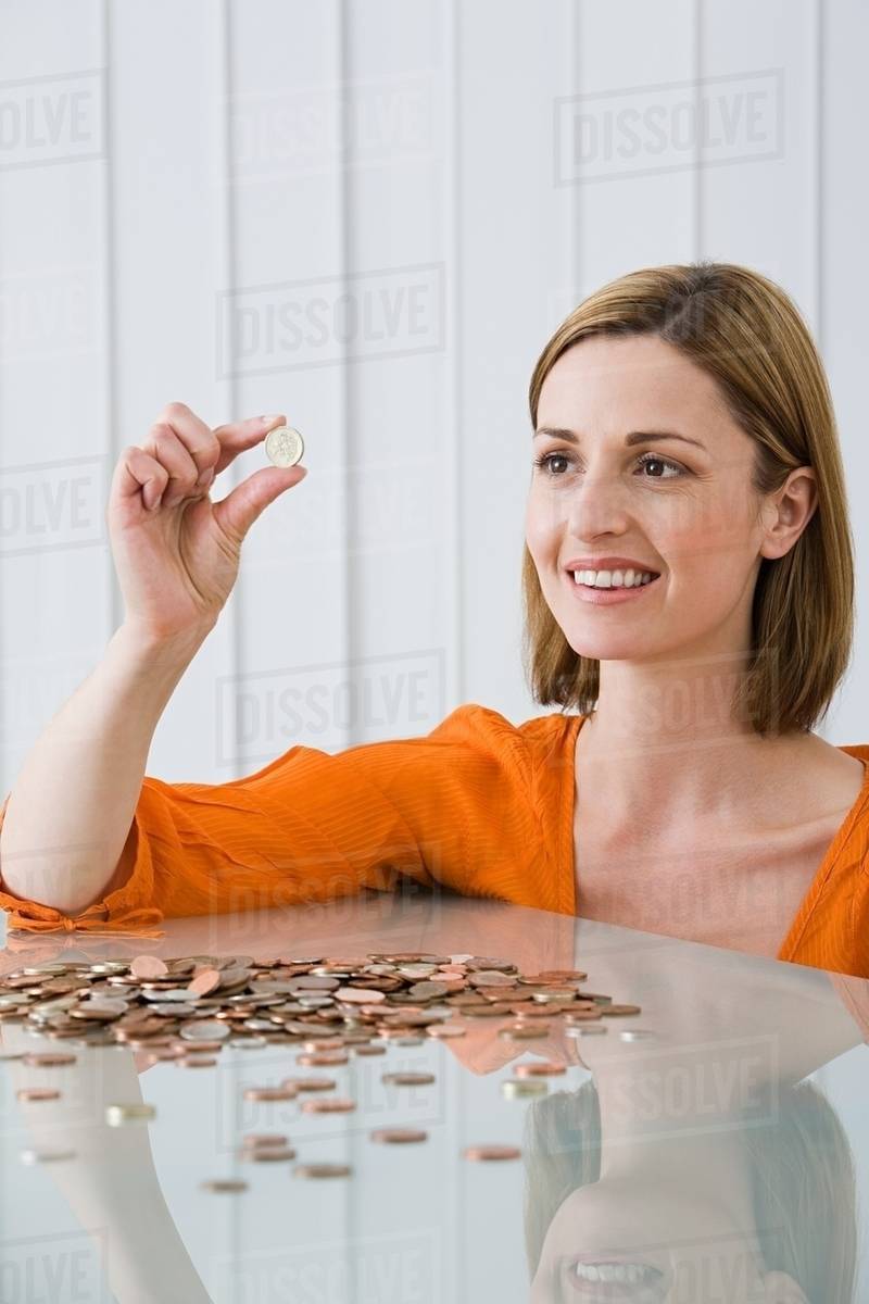 Woman with coins - Royalty-free Stock Photo | Dissolve