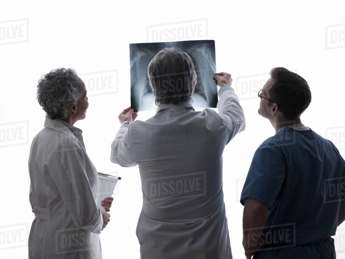 Doctors and surgeon looking at x-ray - Royalty-free Stock Photo | Dissolve