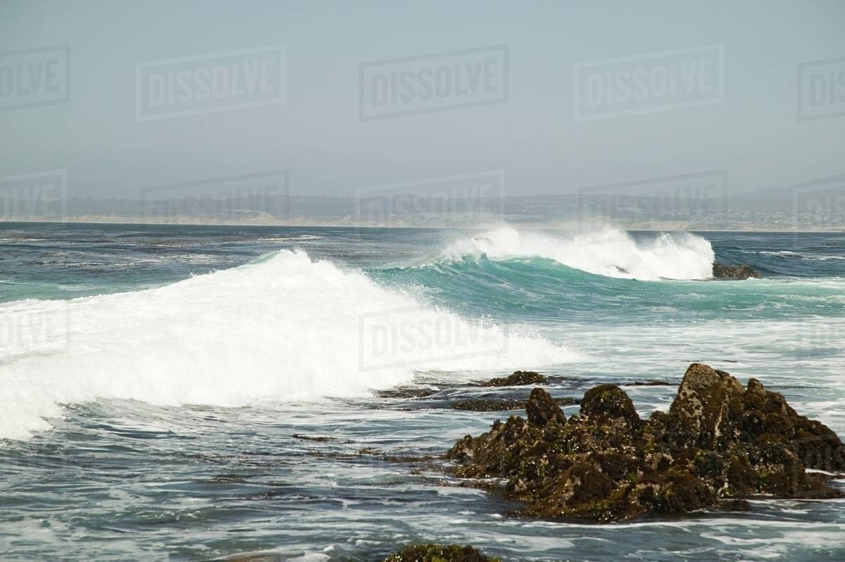 Waves hitting rocks - Stock Photo - Dissolve