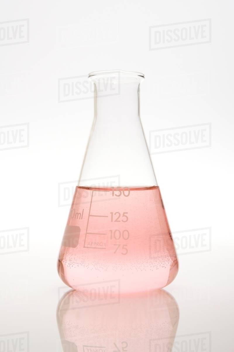 Pink liquid in a volumetric flask - Stock Photo - Dissolve
