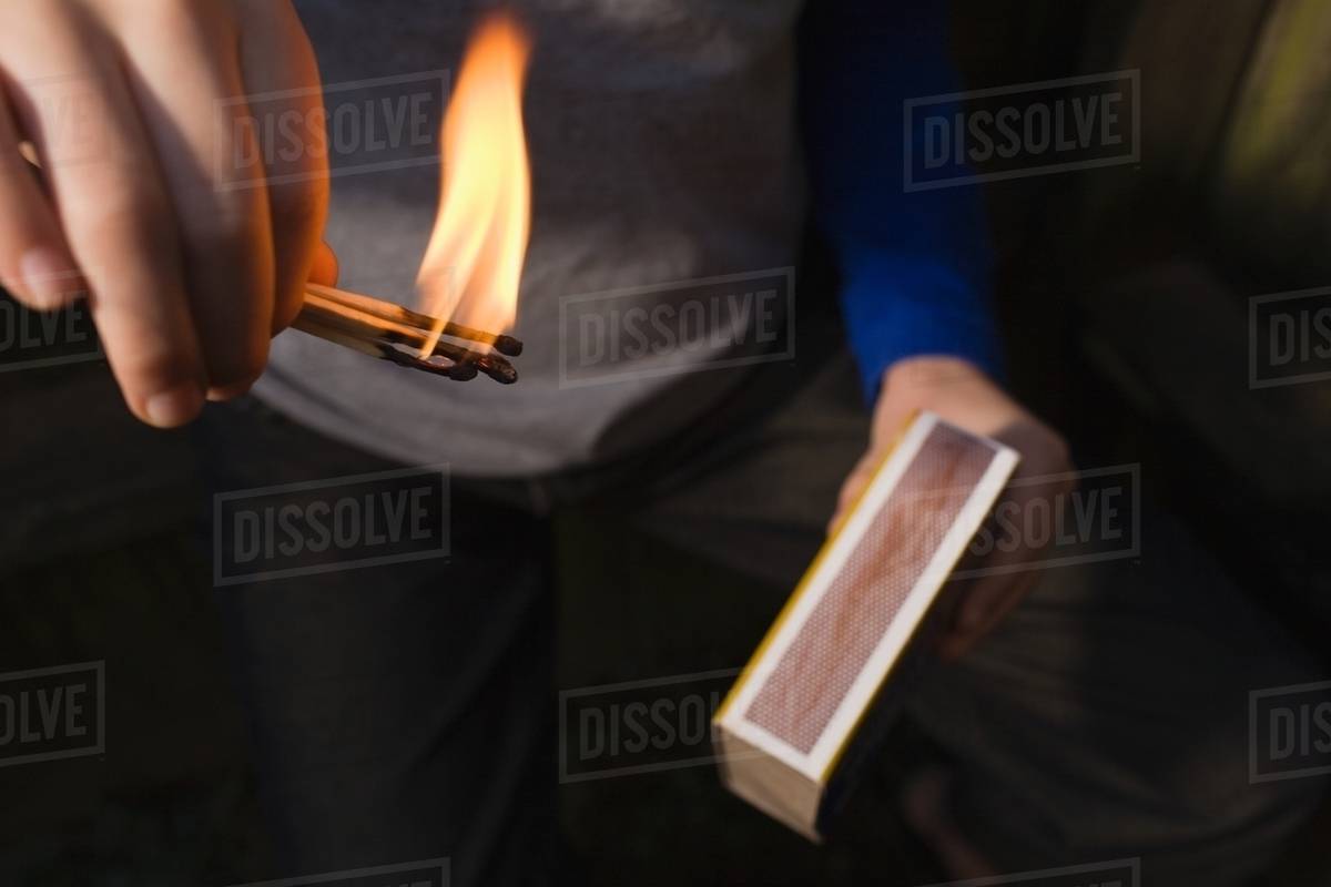 Boy playing with fire - Royalty-free Stock Photo | Dissolve