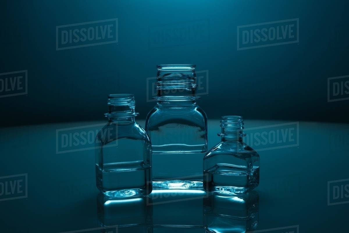 Glass bottles of clear liquid - Royalty-free Stock Photo | Dissolve