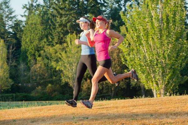 Teenage girls running together in field - Royalty-free Stock Photo ...