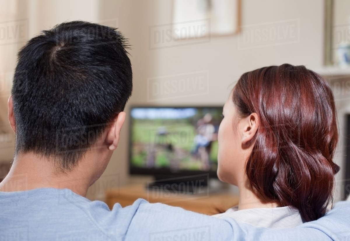 Couple watching television together - Royalty-free Stock Photo | Dissolve
