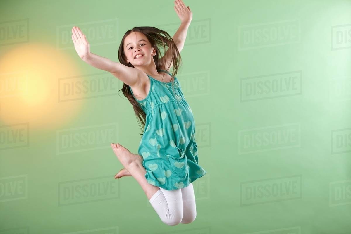 Girl jumping, mid air - Royalty-free Stock Photo | Dissolve