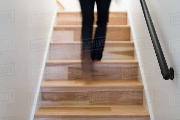 Person walking up steps - Royalty-free Stock Photo | Dissolve