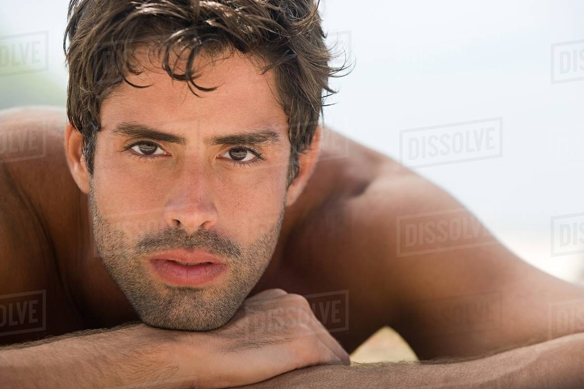 Hispanic man sunbathing - Royalty-free Stock Photo | Dissolve