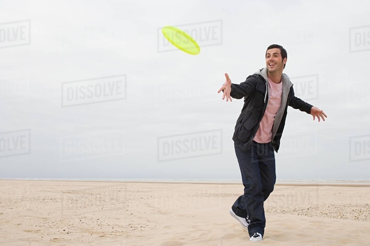 Man throwing a flying disc - Stock Photo - Dissolve