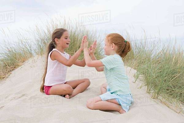 Girls playing pat a cake - Royalty-free Stock Photo | Dissolve