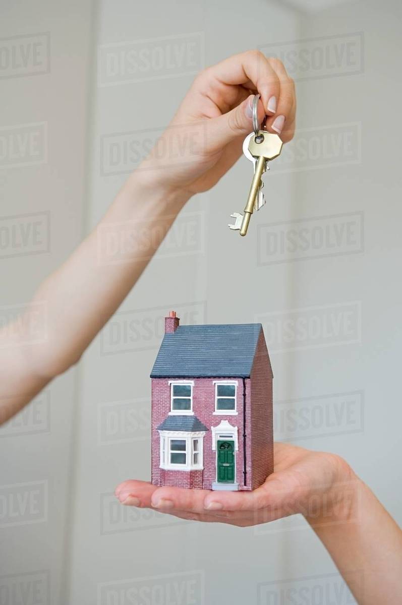 People holding keys and house - Royalty-free Stock Photo | Dissolve