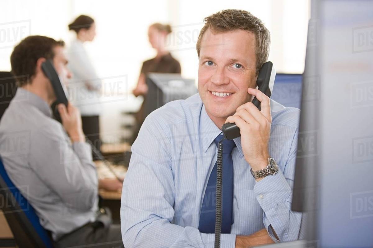 Businessman using a telephone - Stock Photo - Dissolve