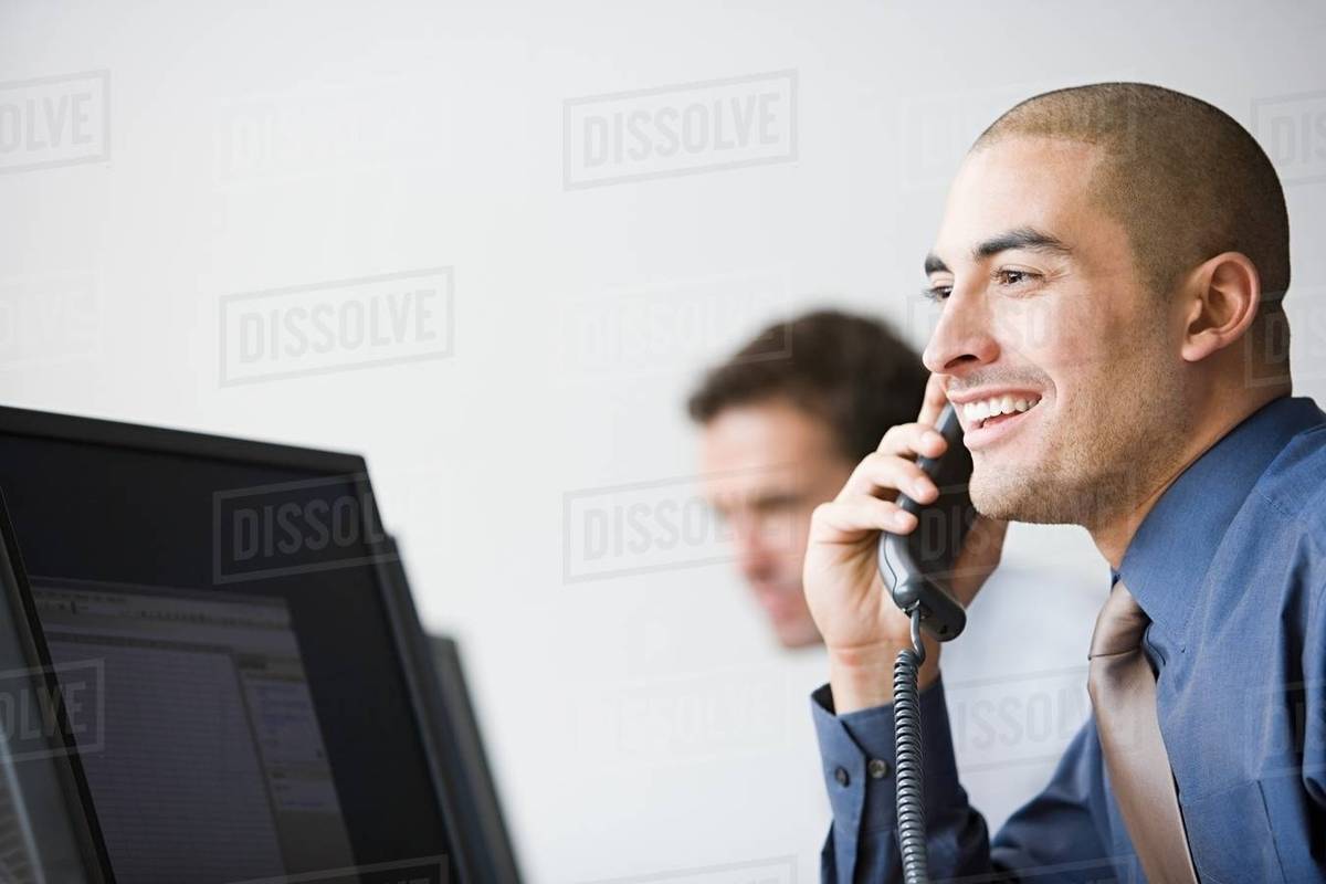 Businessman using a telephone - Stock Photo - Dissolve