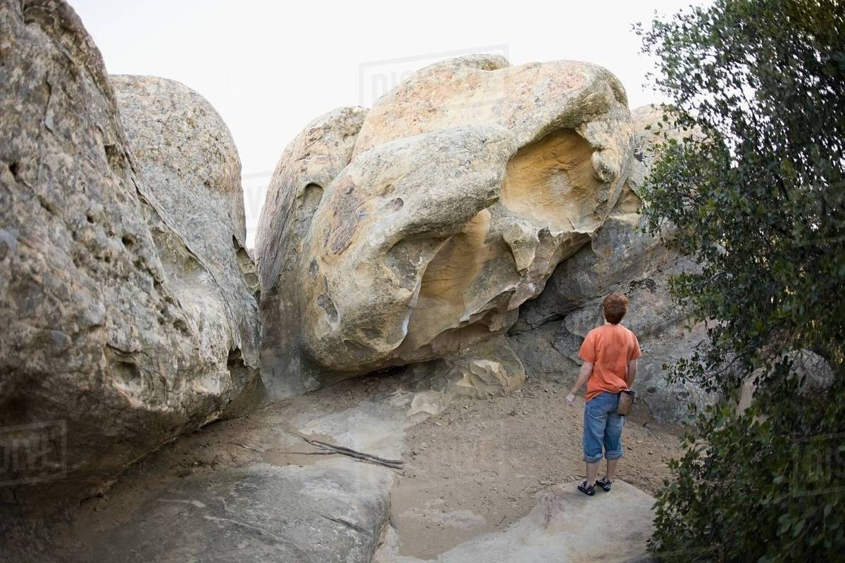 Rock climber looking at rocks - Stock Photo - Dissolve