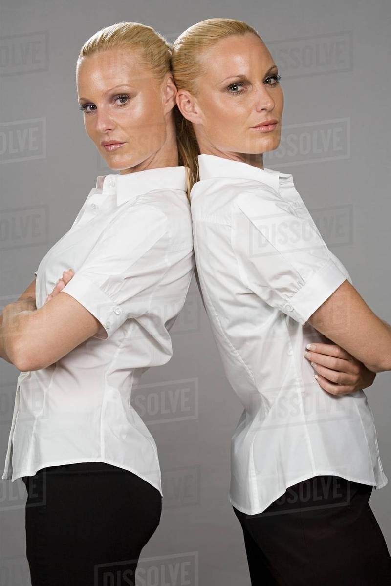 Twins back to back - Royalty-free Stock Photo | Dissolve