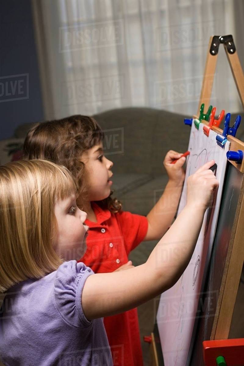 Two girls drawing - Royalty-free Stock Photo | Dissolve