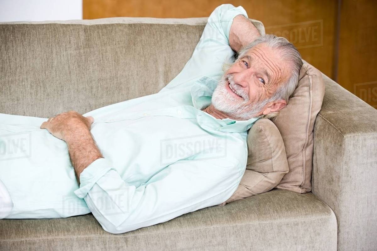 A senior man reclining on a sofa - Royalty-free Stock Photo | Dissolve