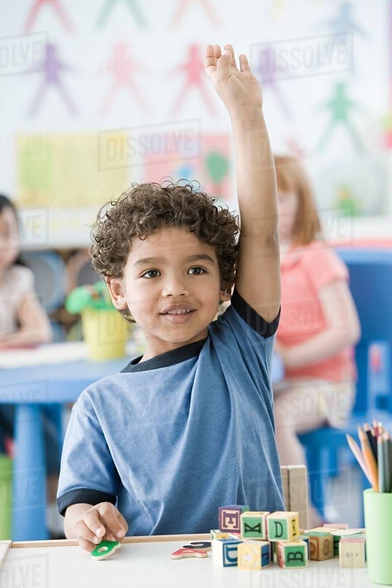 Boy raising arm - Stock Photo - Dissolve