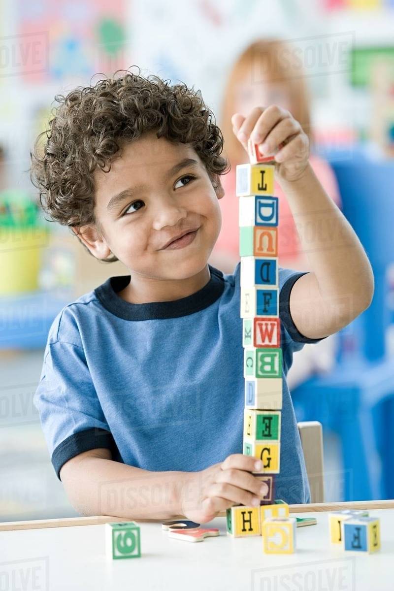 Boy playing with building blocks - Royalty-free Stock Photo | Dissolve