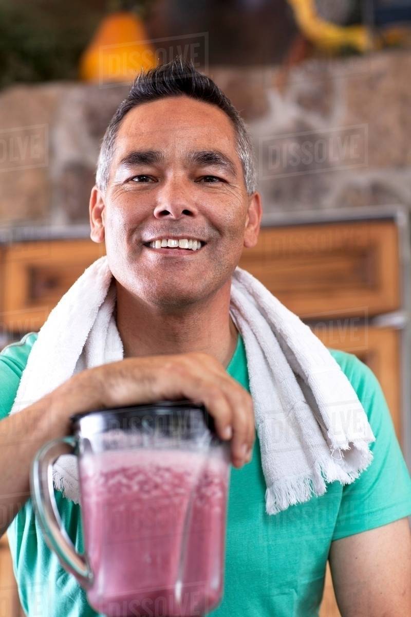 Man making smoothie in kitchen - Stock Photo - Dissolve