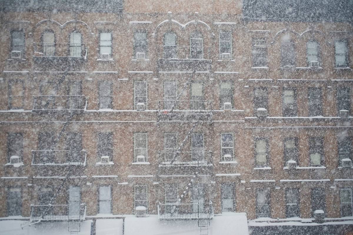 Snow falling by apartment buildings - Royalty-free Stock Photo | Dissolve