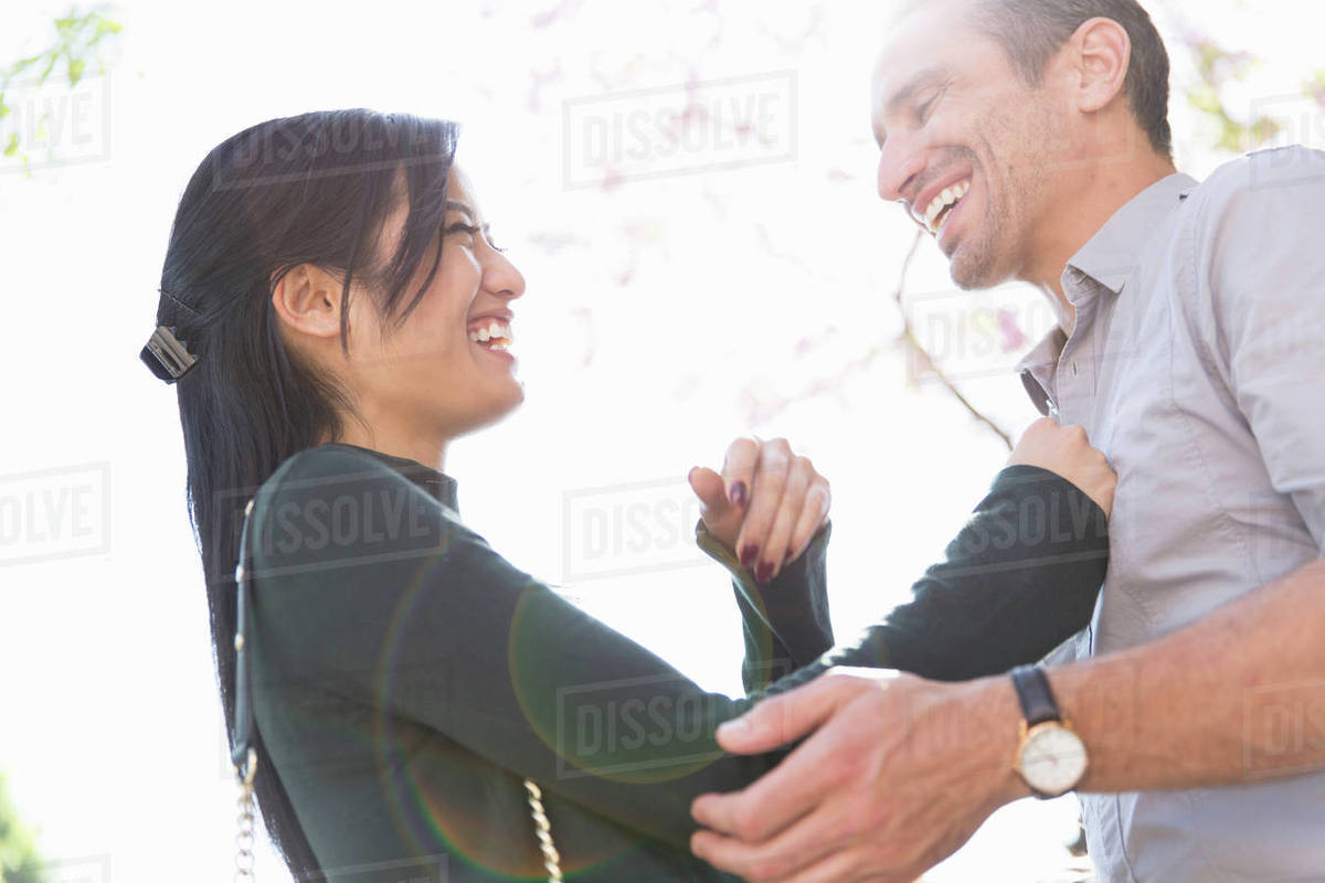 Low angle view of couple face to face smiling - Royalty-free Stock ...
