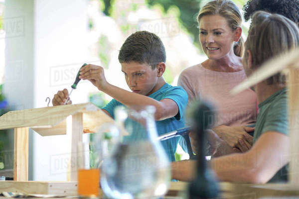 Family doing crafts together, making birdhouse - Royalty-free Stock ...