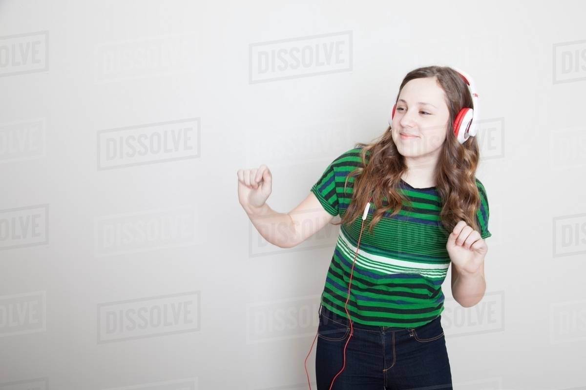 Girl dancing wearing headphones - Royalty-free Stock Photo | Dissolve