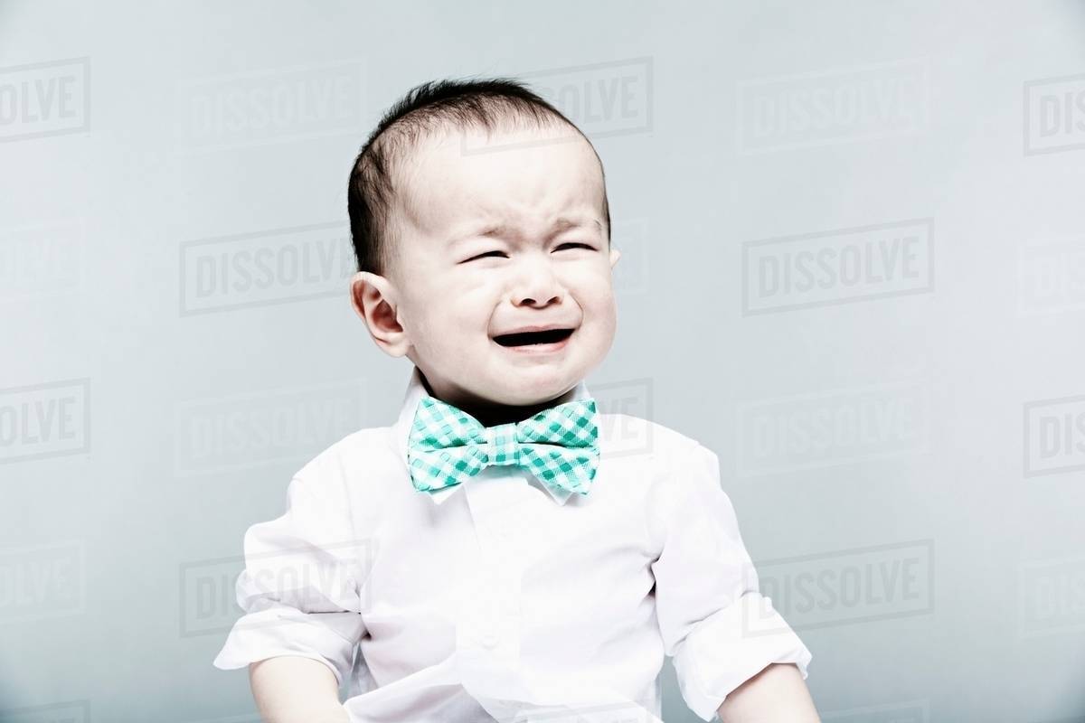 Portrait of baby boy wearing shirt and bow tie, crying - Royalty-free ...